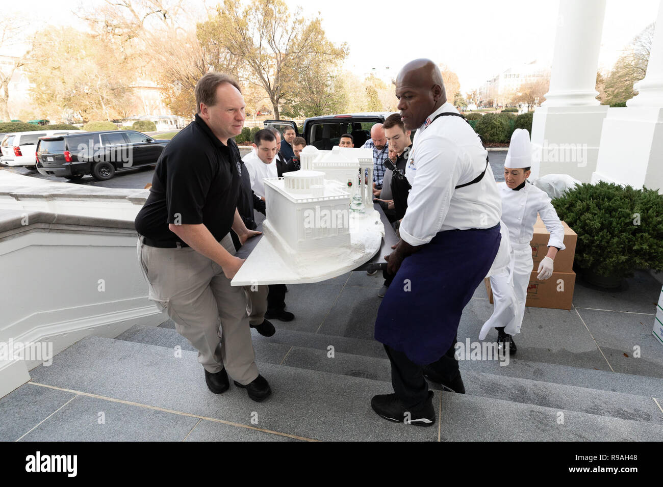 White House Staff and chefs carry the gingerbread house through the ...