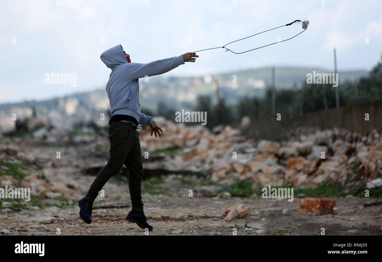 Nablus, West Bank. 21st Dec, 2018. A Palestinian protester uses a ...