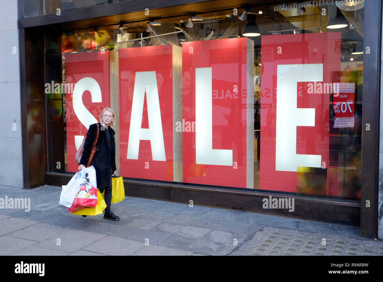 Shoppers walk past sale signs on oxford street hi-res stock photography ...