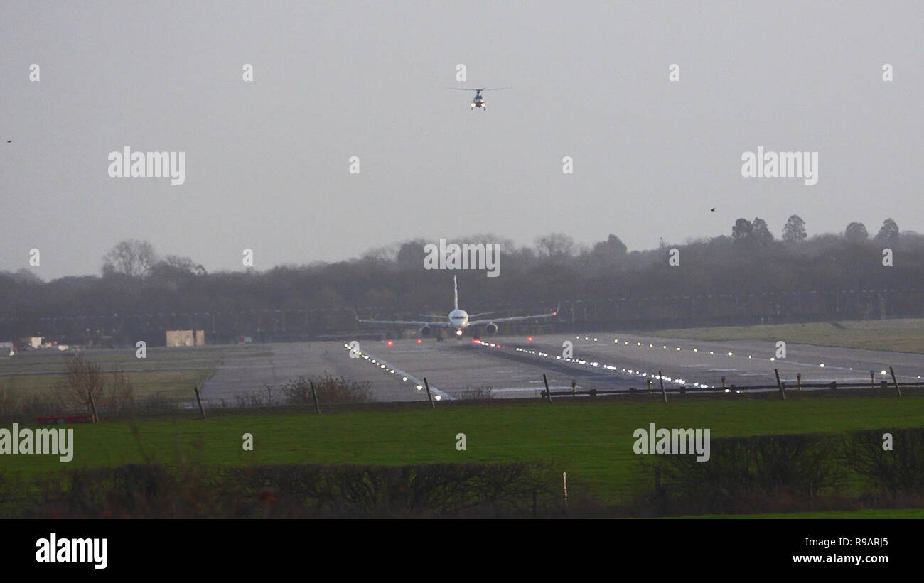 Gatwick Drone attack - helicopter flying above plane on runway Stock ...