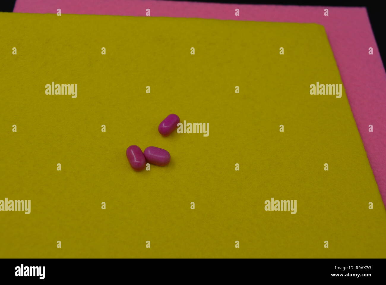 Delicious sweet dragees, tic tac candies so raspberry and white with ...