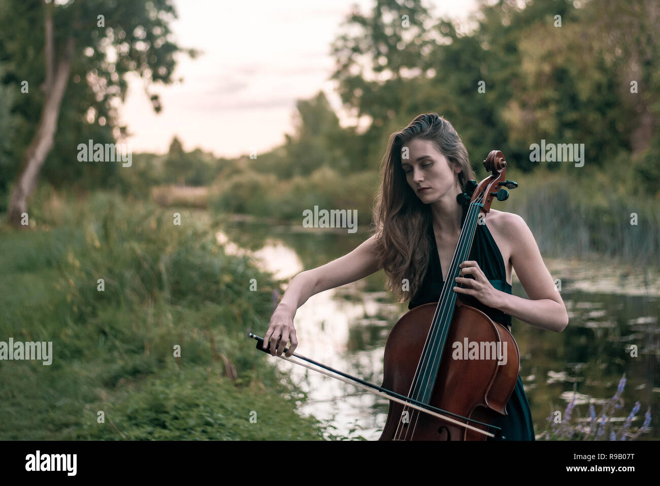 Female Cellist plays in the Park Stock Photo - Alamy