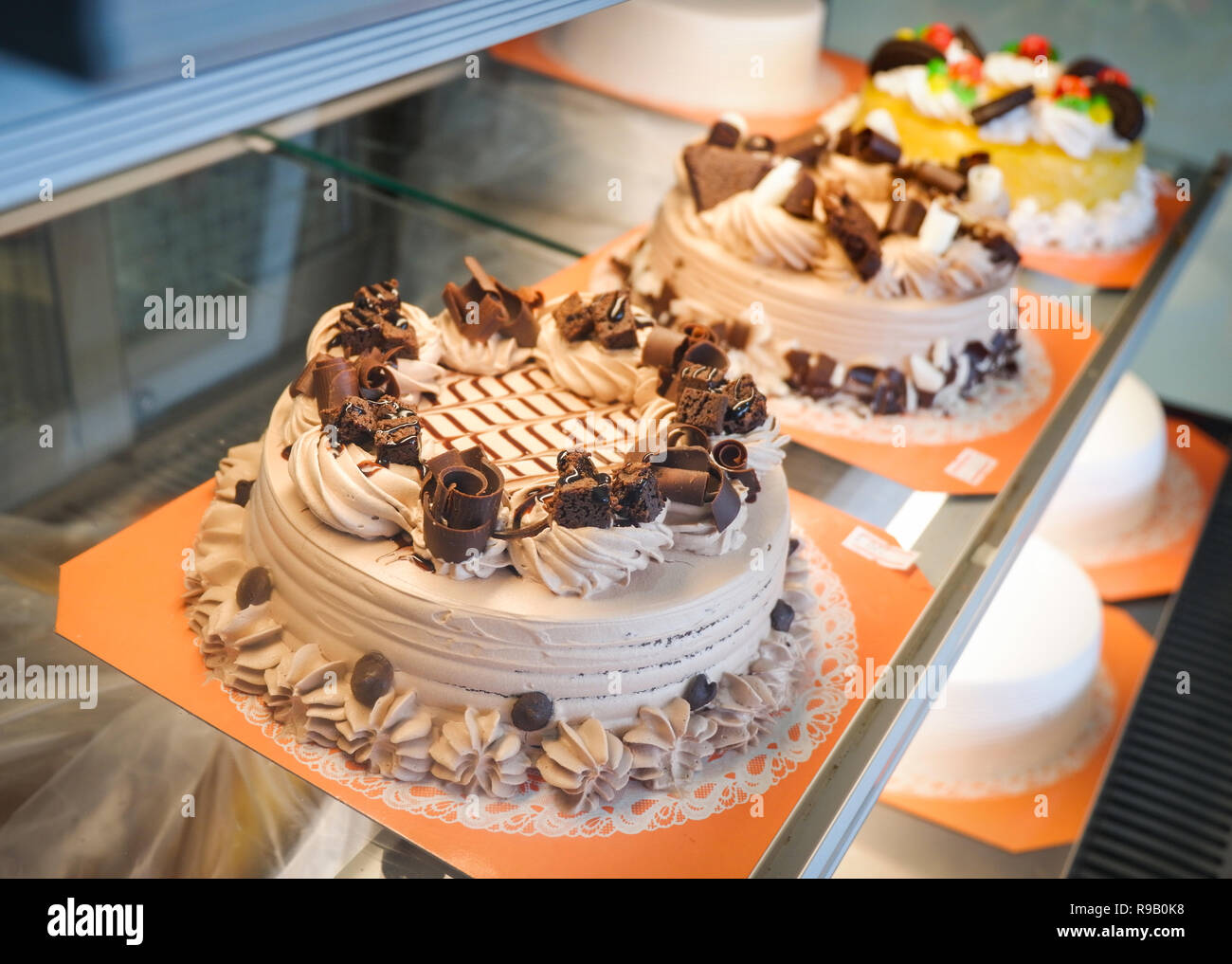 Different types Cake in showcase / tray cake in glass display at store ...