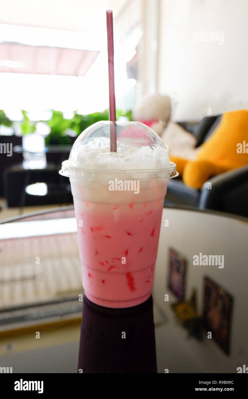 Strawberry milk pink shake / Iced pink milk in plastic cup and straw on ...