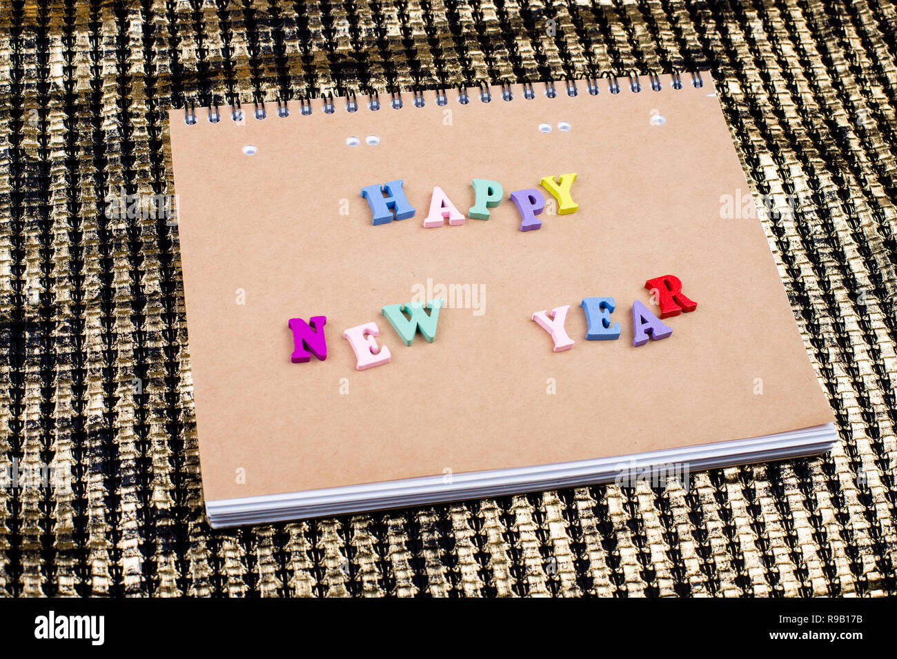 Notepad of kraft paper on a golden background with the inscription ...