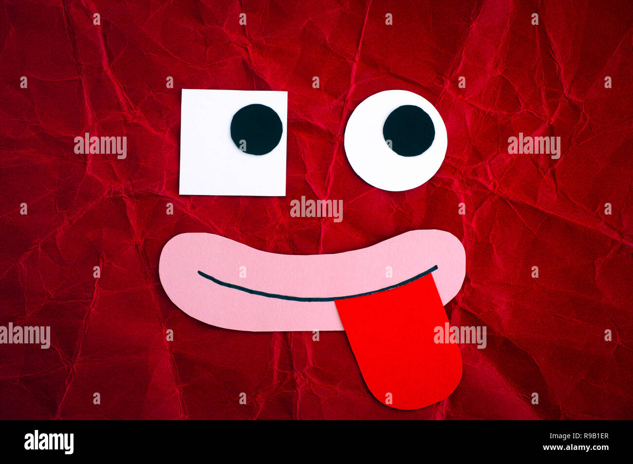 Funny face with different eyes and tongue stuck out. Emotional face ...