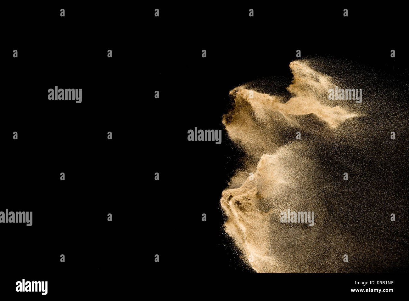 Dry river sand explosion. Golden color sand splash against black ...