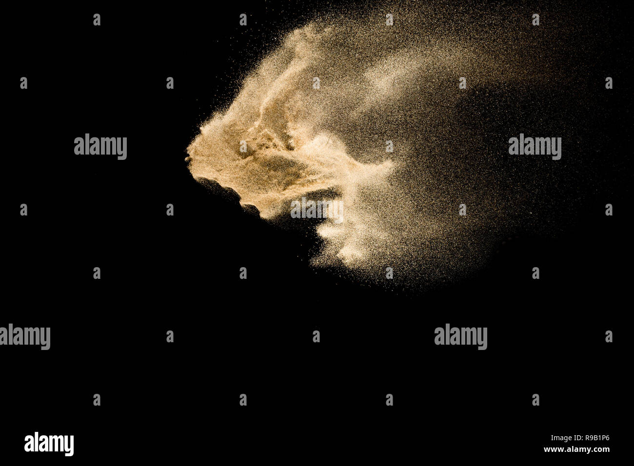 Dry river sand explosion. Golden color sand splash against black ...