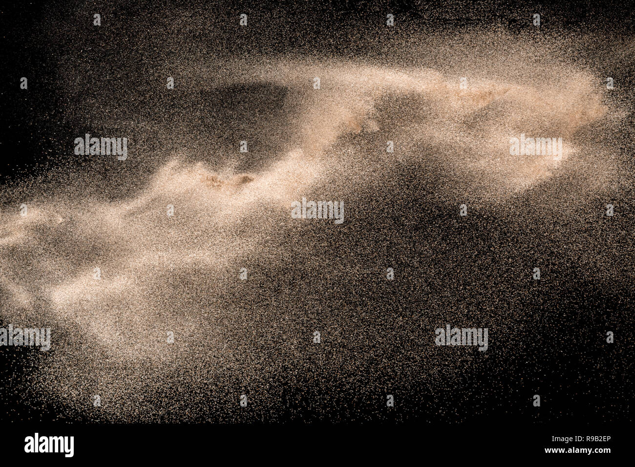 Dry river sand explosion. Golden colored sand splash against black ...