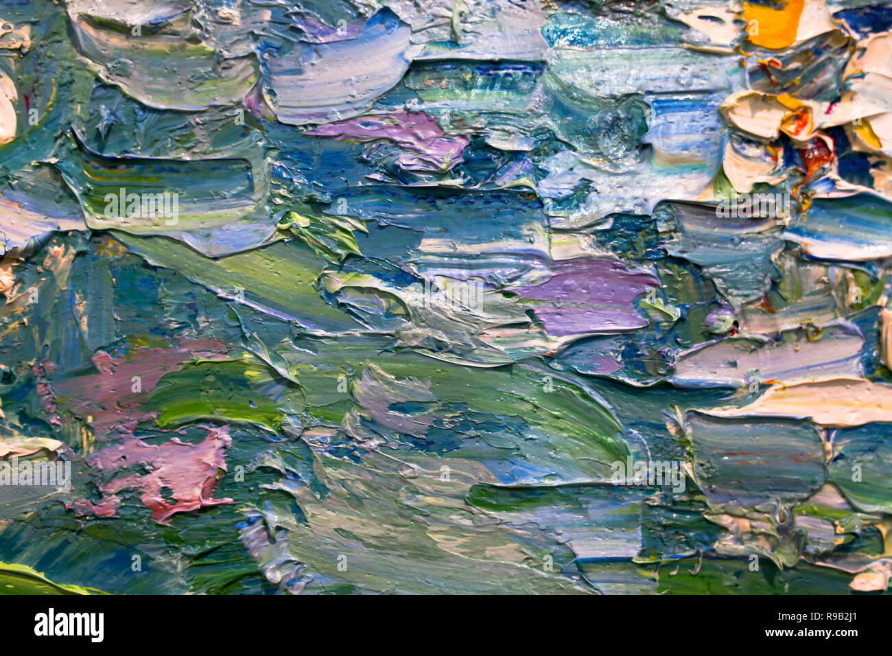 multi-colored strokes of oil paint on the artist's palette. the texture ...