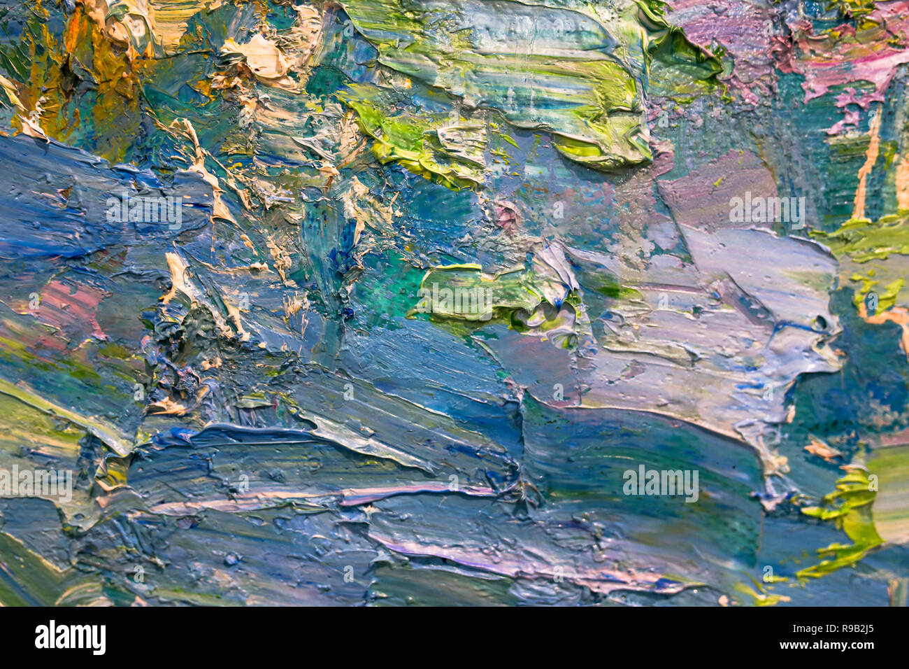 multi-colored strokes of oil paint on the artist's palette. the texture ...