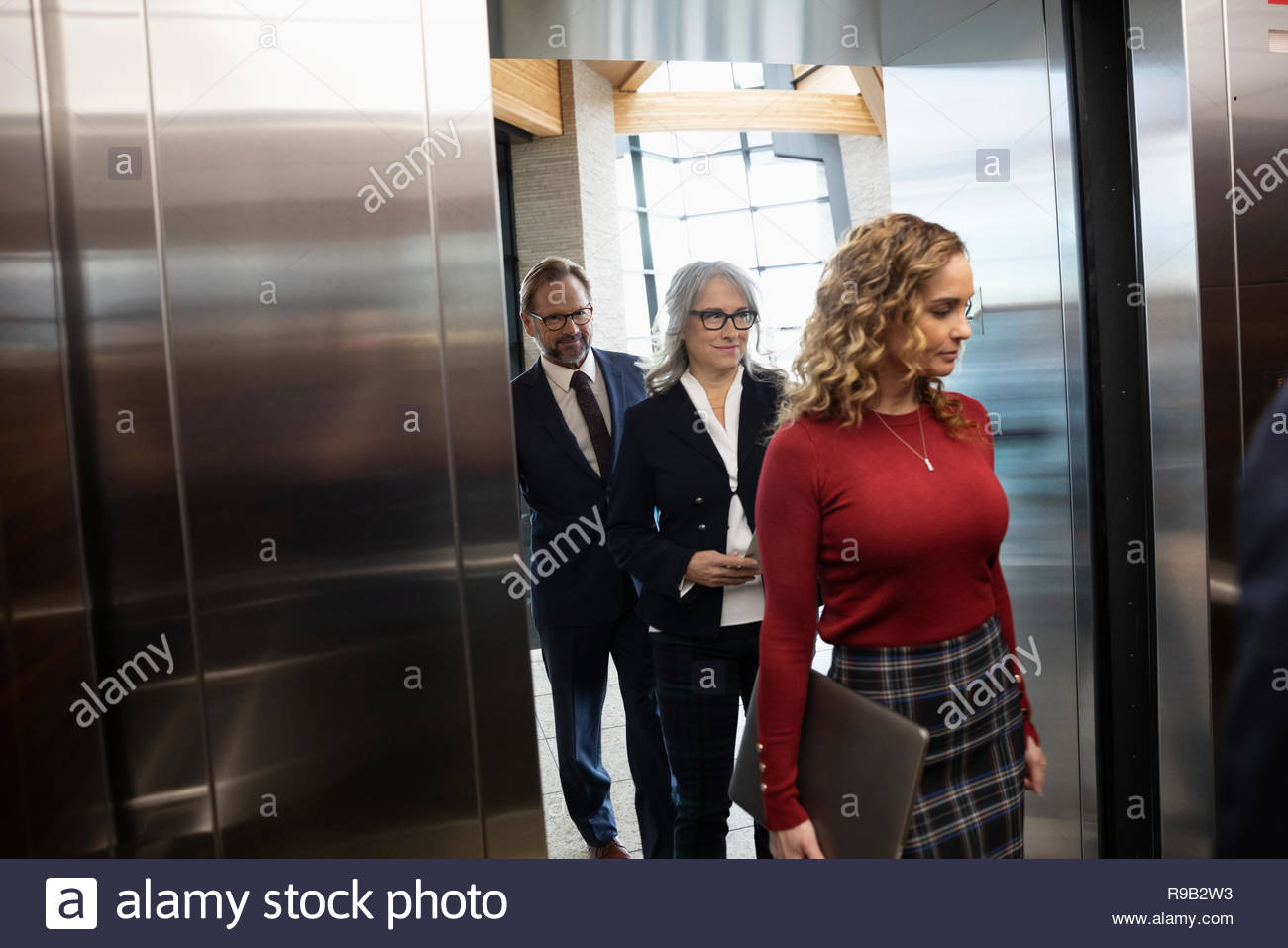 Business people entering elevator Stock Photo - Alamy