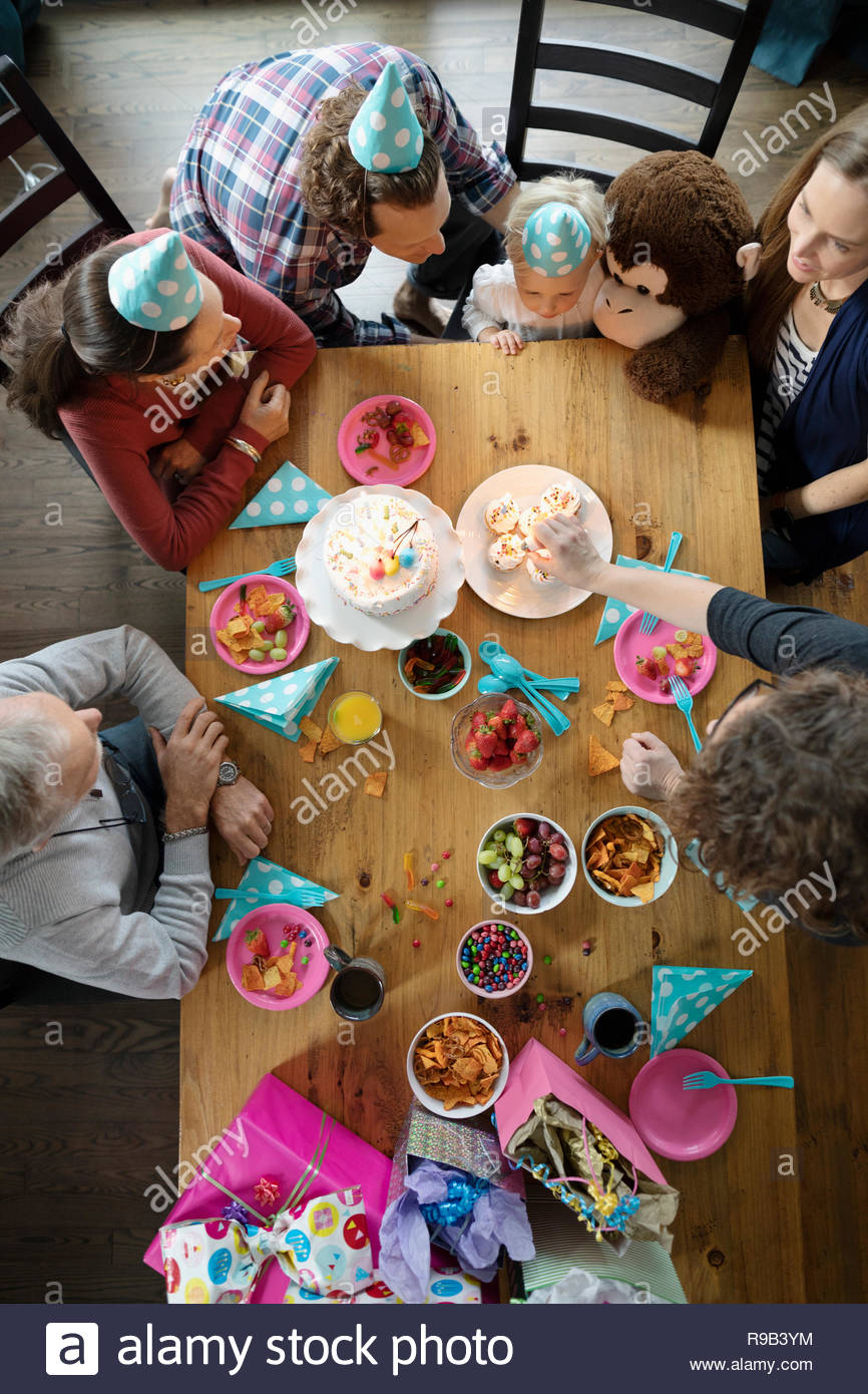 View from above multi-generation family celebrating birthday at dining ...