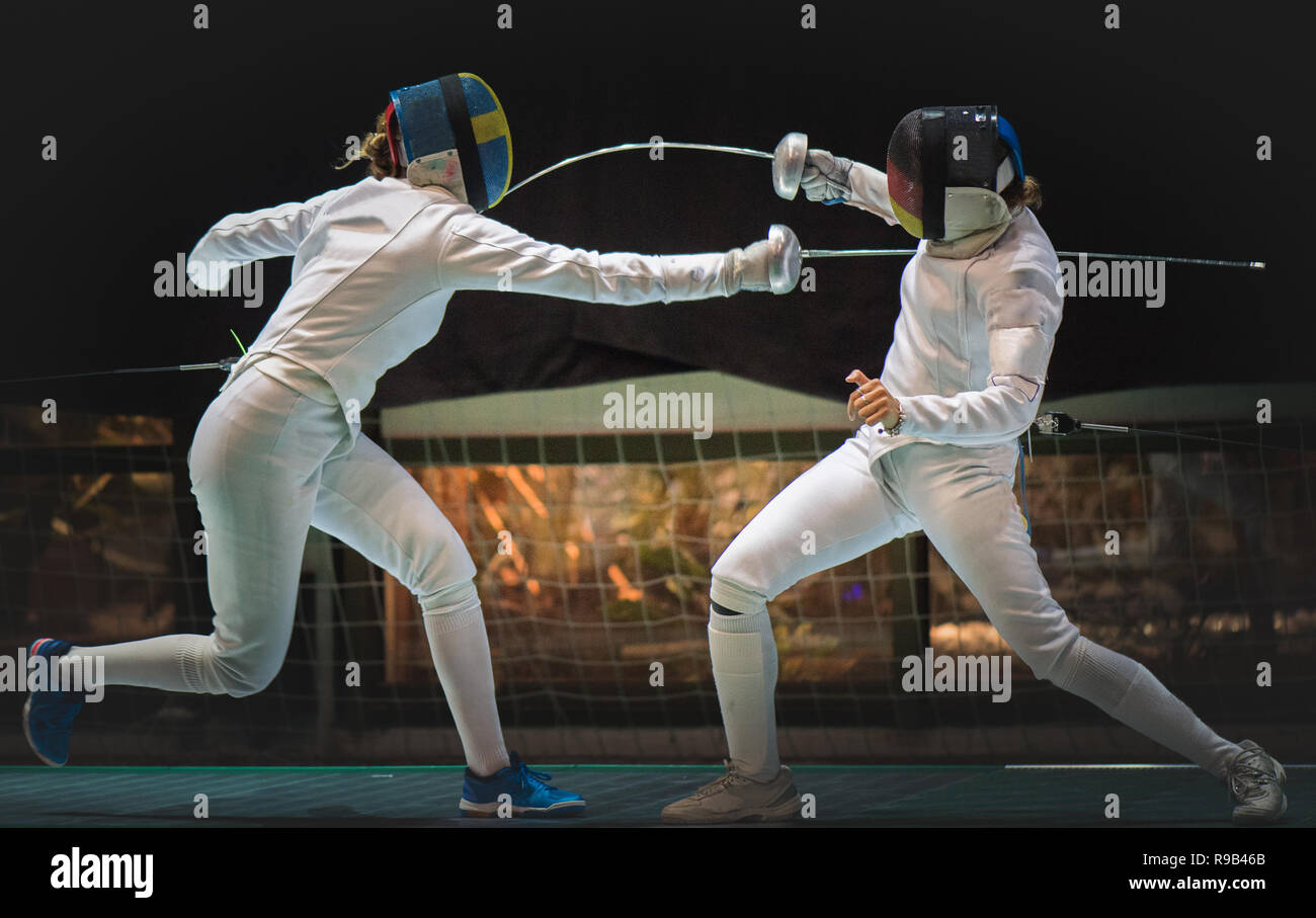 Two man fencing athletes fight on professional sports arena Stock Photo ...