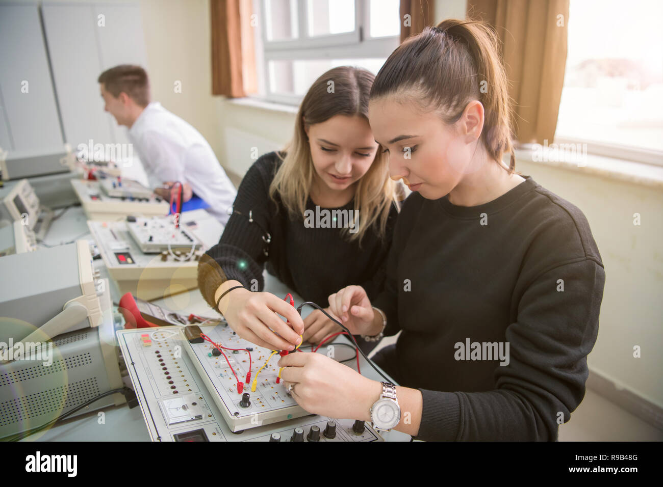Group of young students doing technical vocational practice with ...