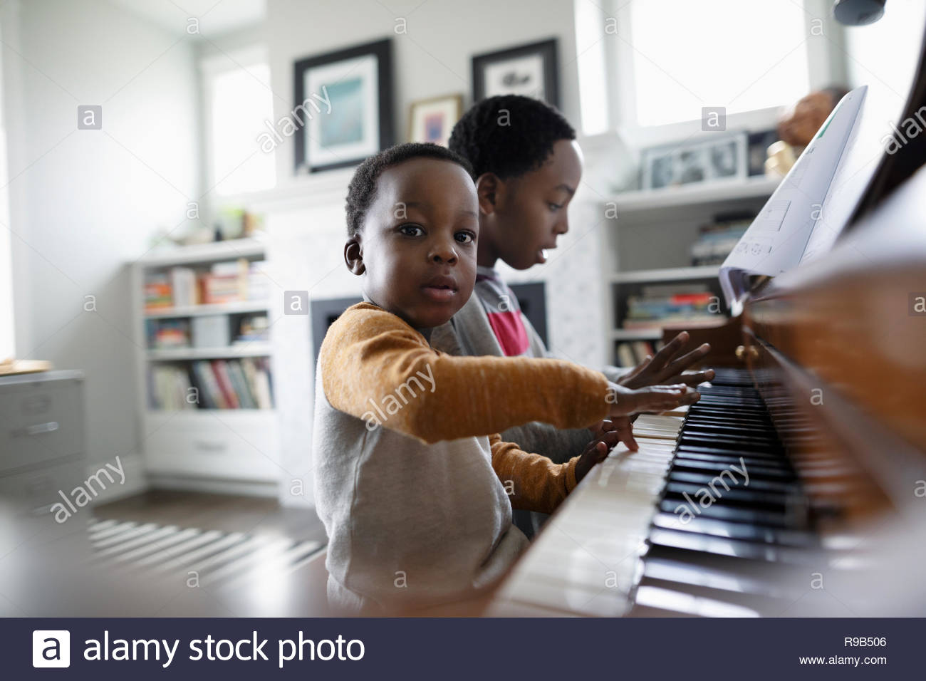 Boy playing piano hi-res stock photography and images - Alamy