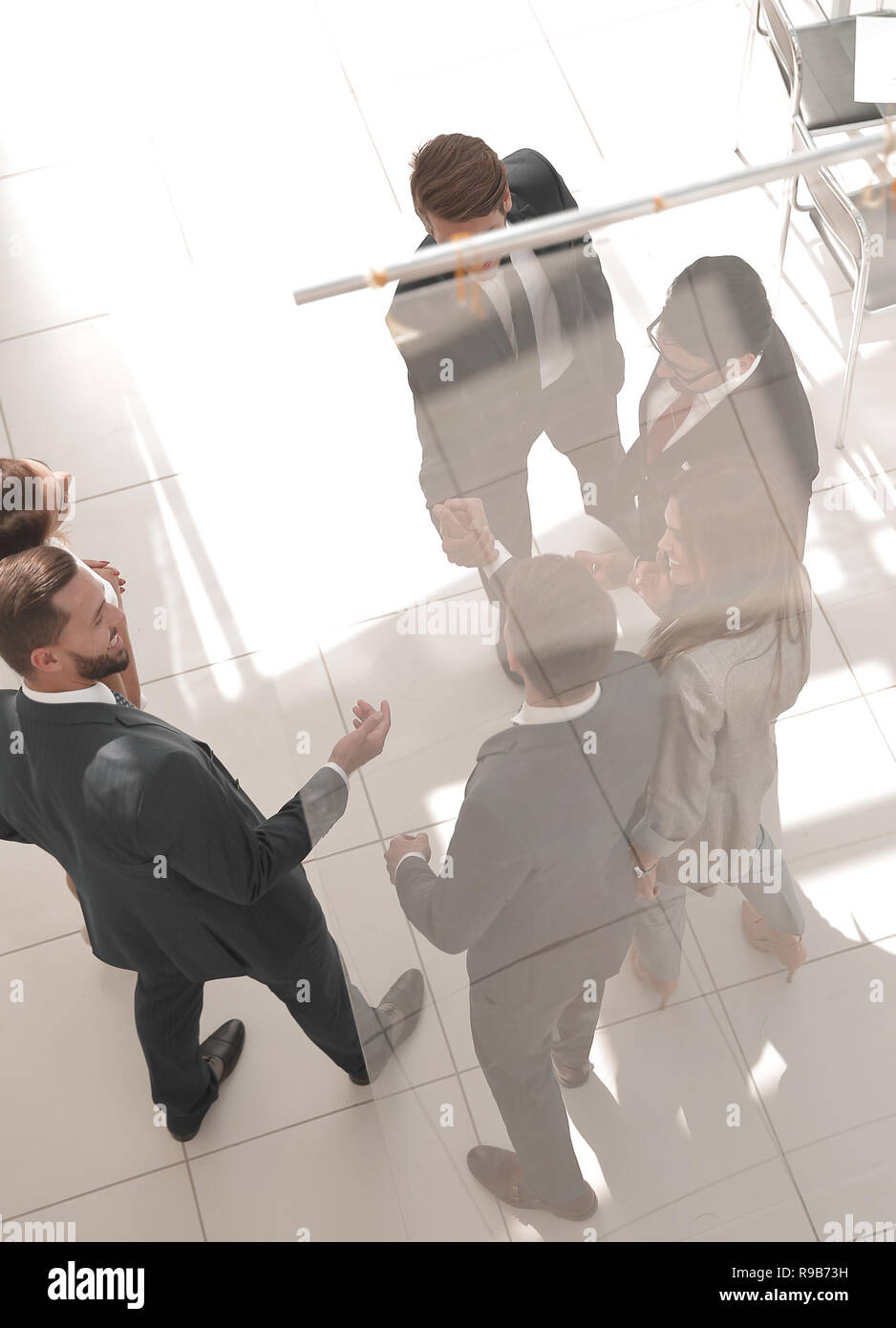 top view. colleagues are talking in the hall Stock Photo - Alamy