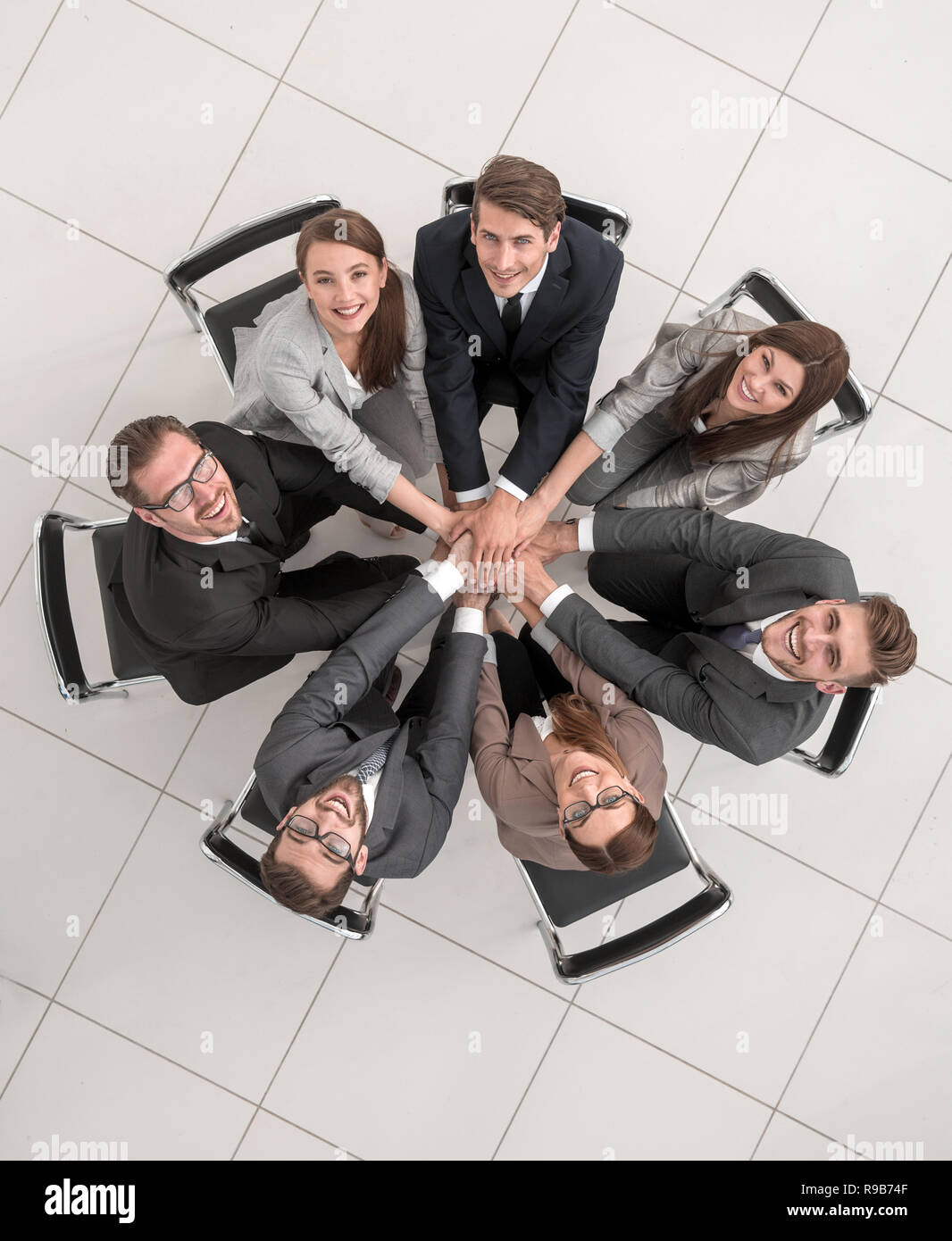 top view.smiling business team making a tower out of hands Stock Photo ...