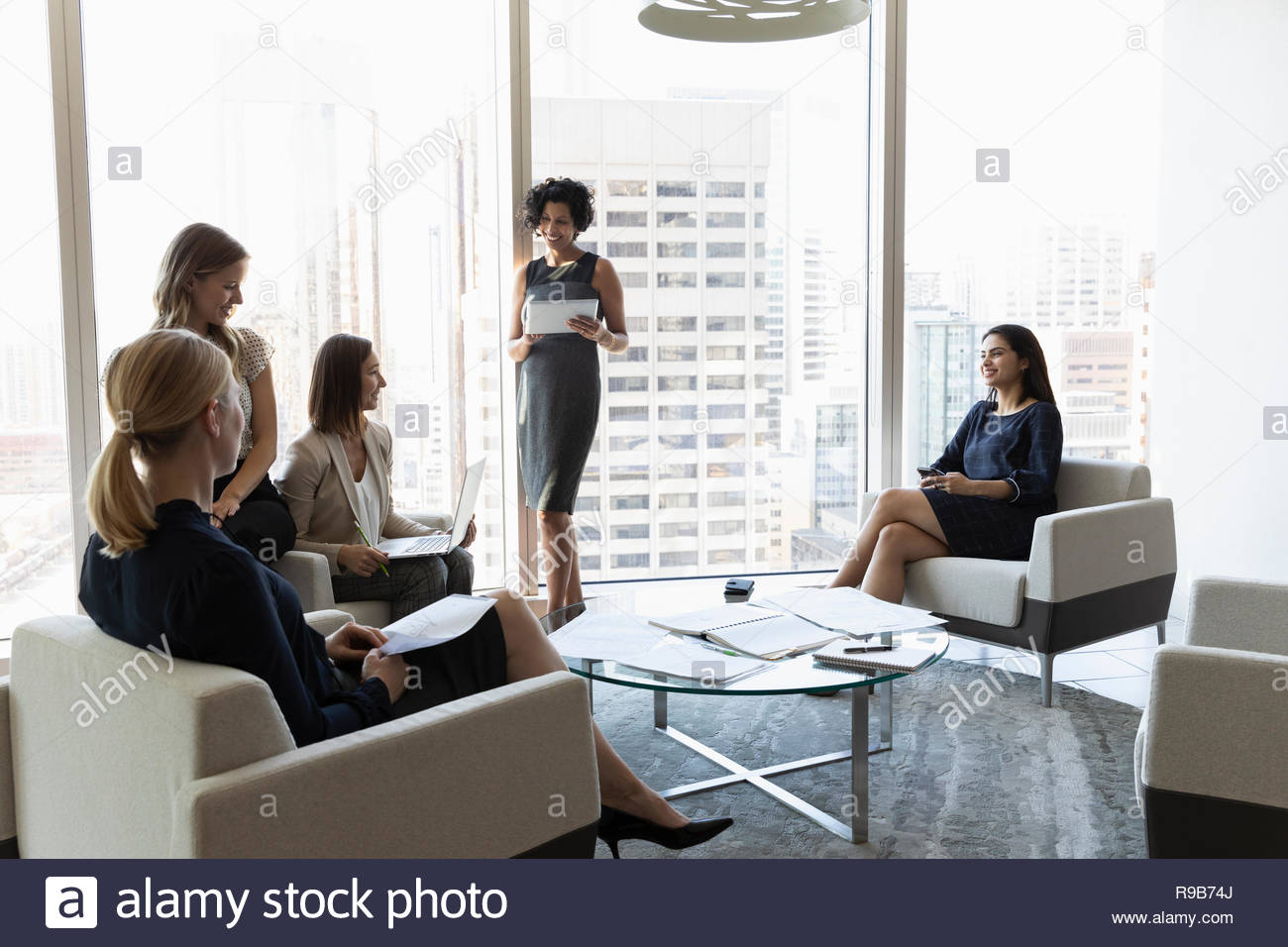 Woman crossed legs standing office hi-res stock photography and images ...