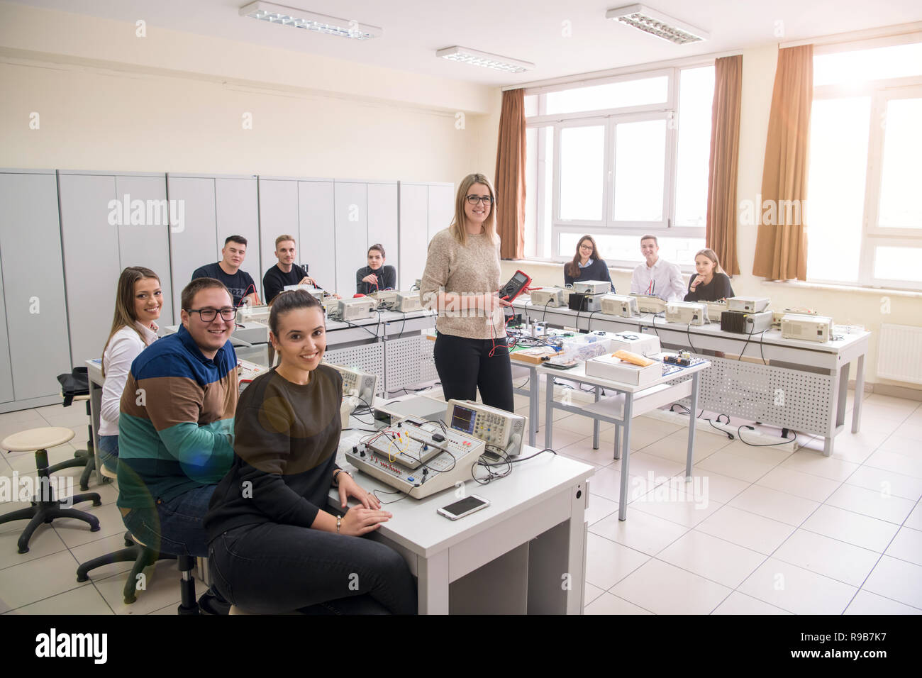 Group of young students doing technical vocational practice with ...