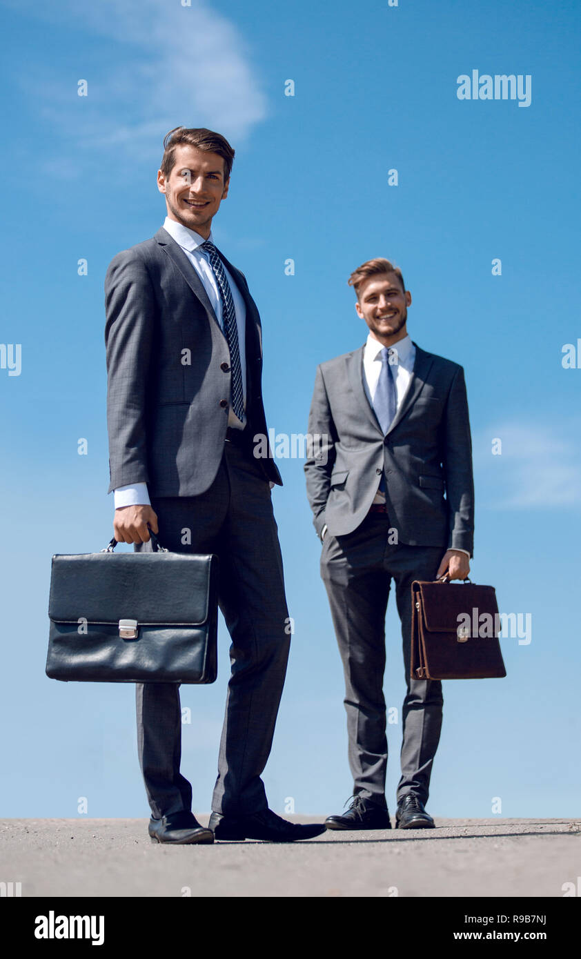 two smiling business men with leather briefcases Stock Photo - Alamy