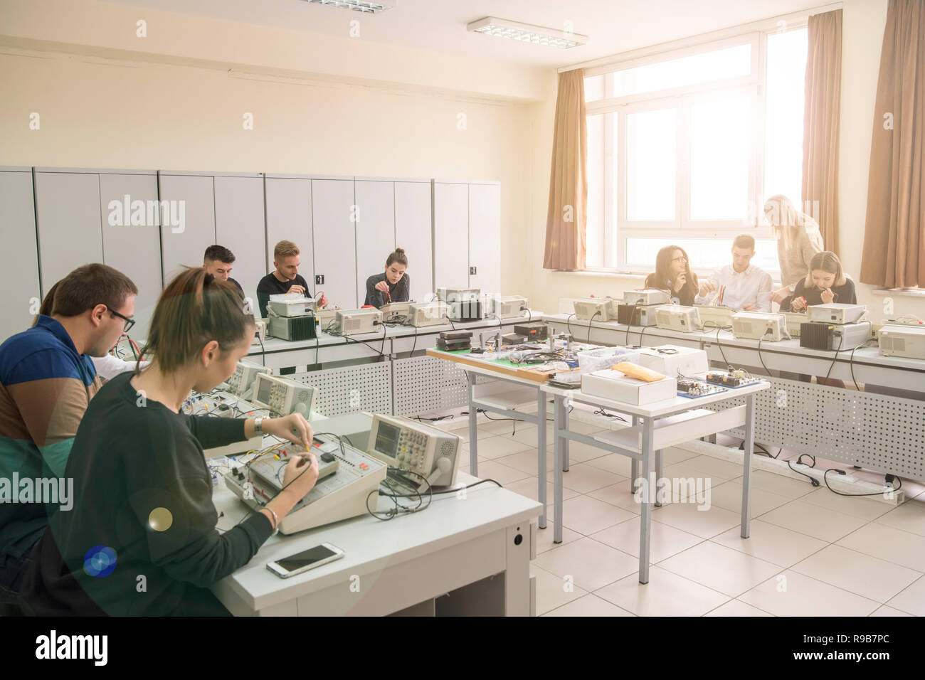Group of young students doing technical vocational practice with ...