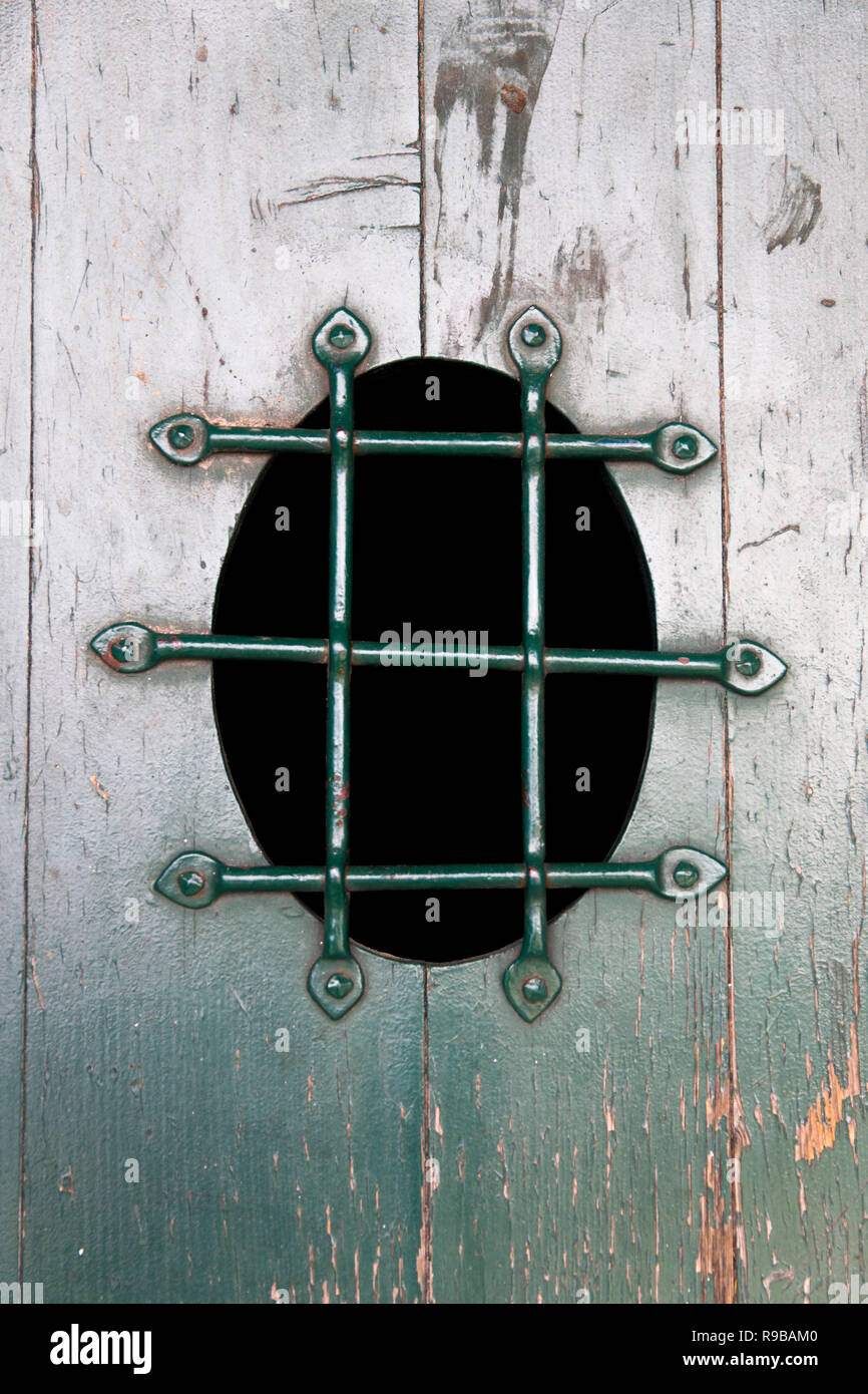 View at old round window with metal bars Stock Photo - Alamy