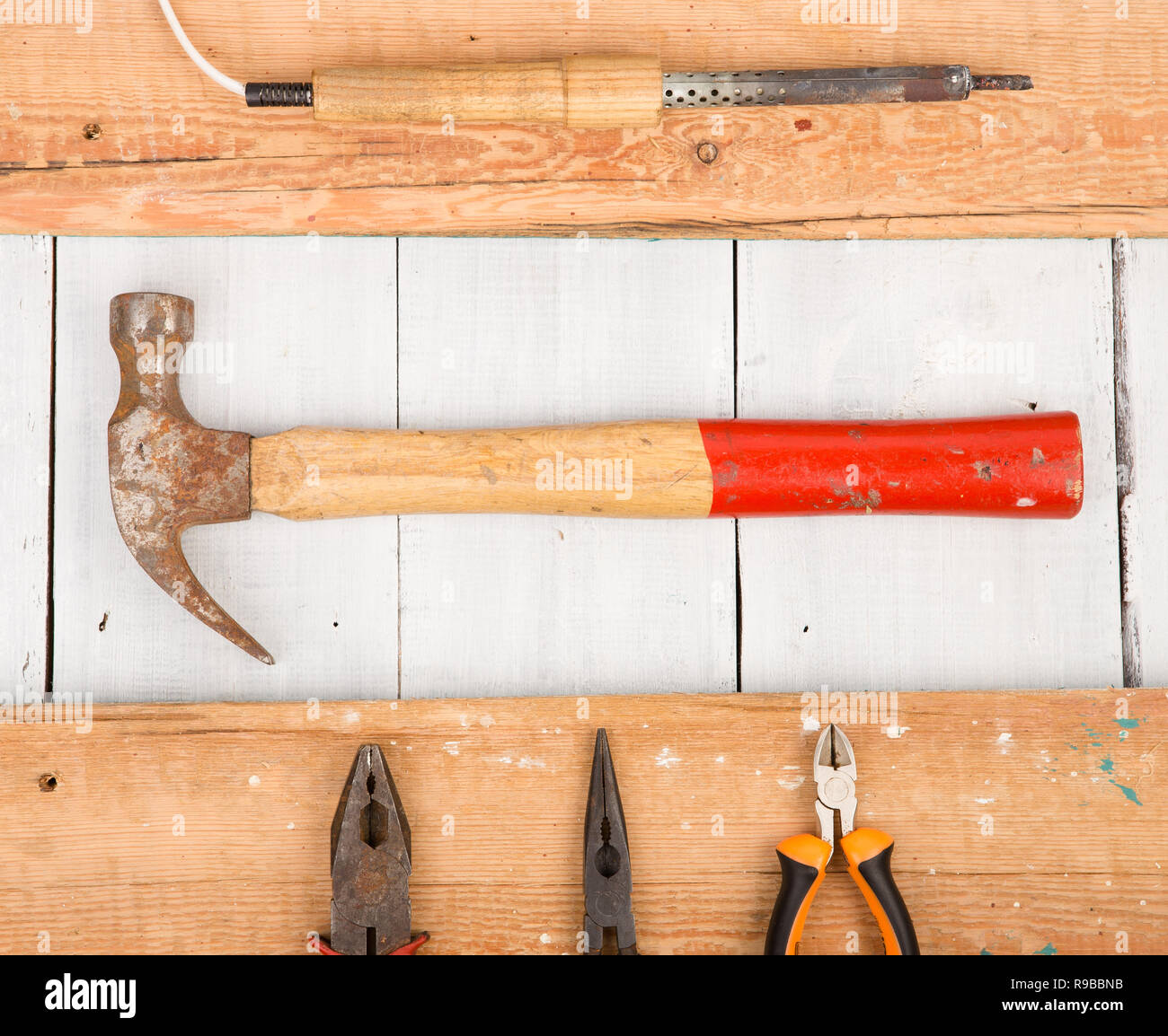 Set of old tools - hammer, pliers and soldering Iron on wooden ...