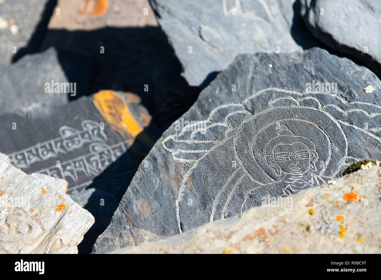 Mani stones, inscribed with buddhist mantras are found across the ...