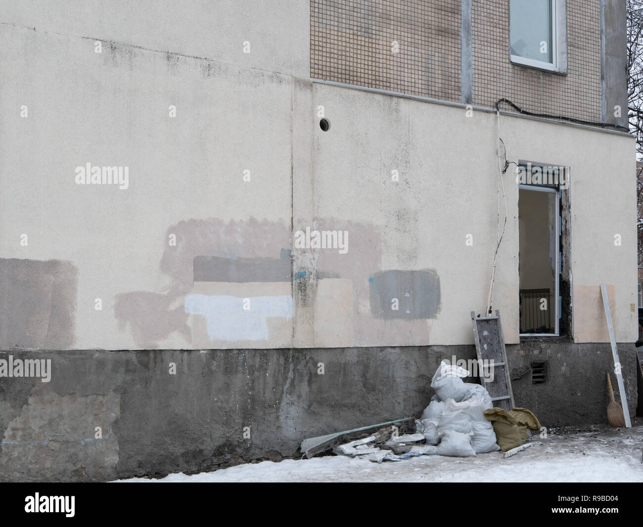 facade side of a building with freshly installed door. workers broke ...