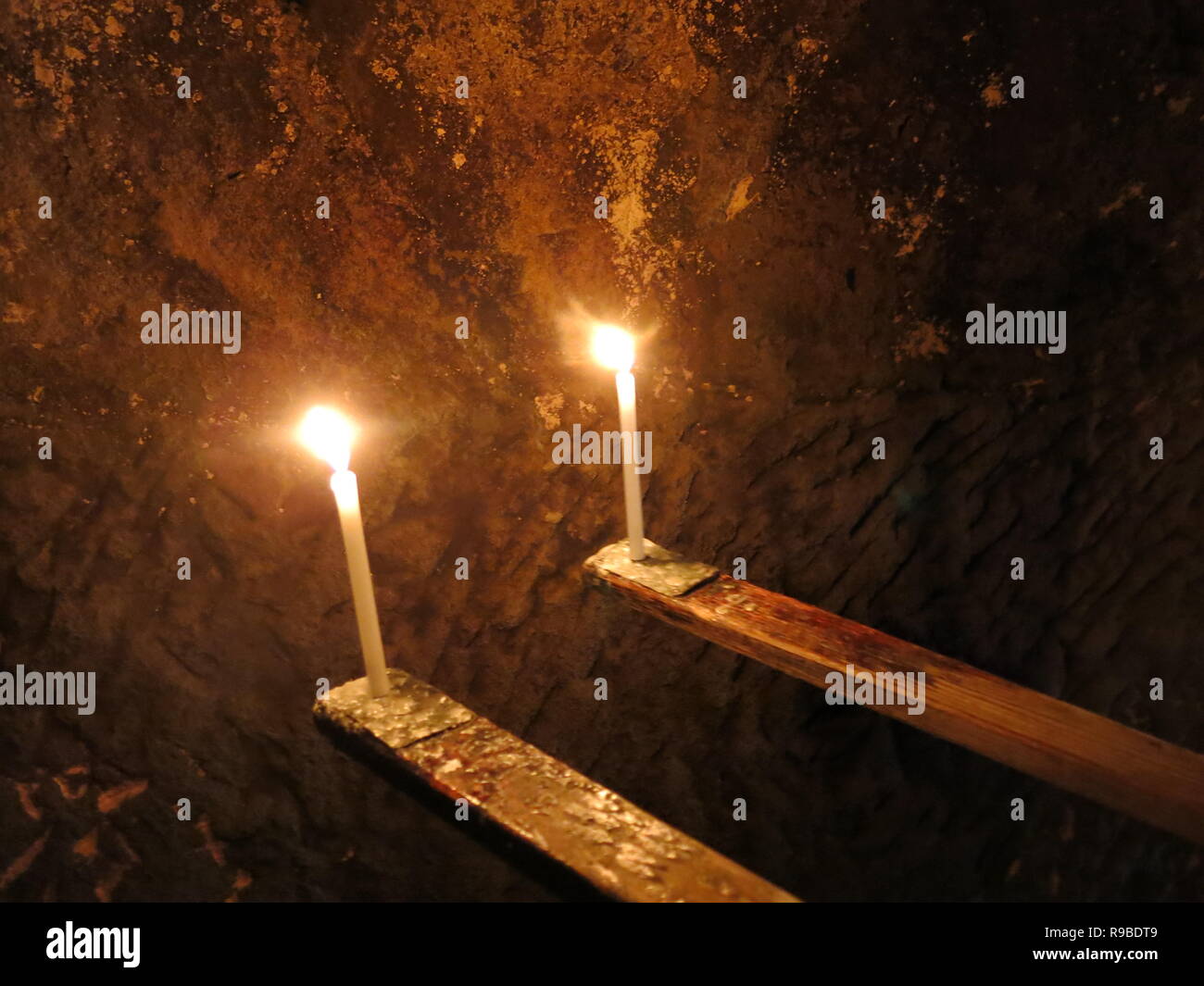 Candles light up the interior of the Taya Caves at Kamakura, carved ...