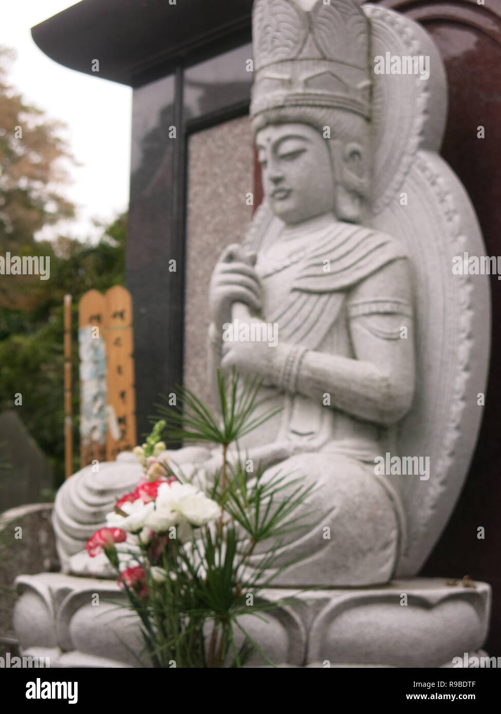 A large statue outside the Taya Caves at Kamakura; in the grounds of ...