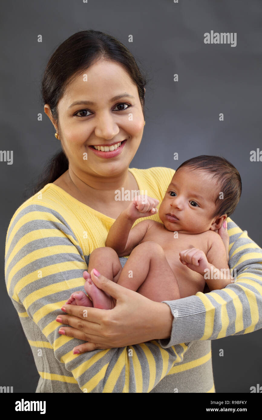 Cheerful mother with newborn baby Stock Photo - Alamy