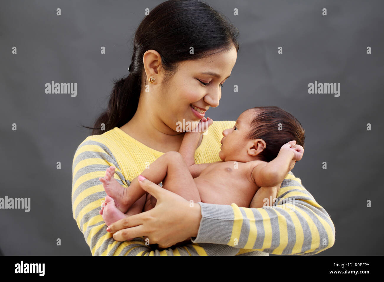 Cheerful mother with newborn baby Stock Photo - Alamy