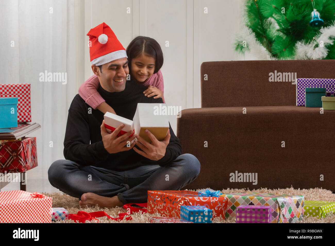 Father opening a present with daughter at Christmas Stock Photo - Alamy