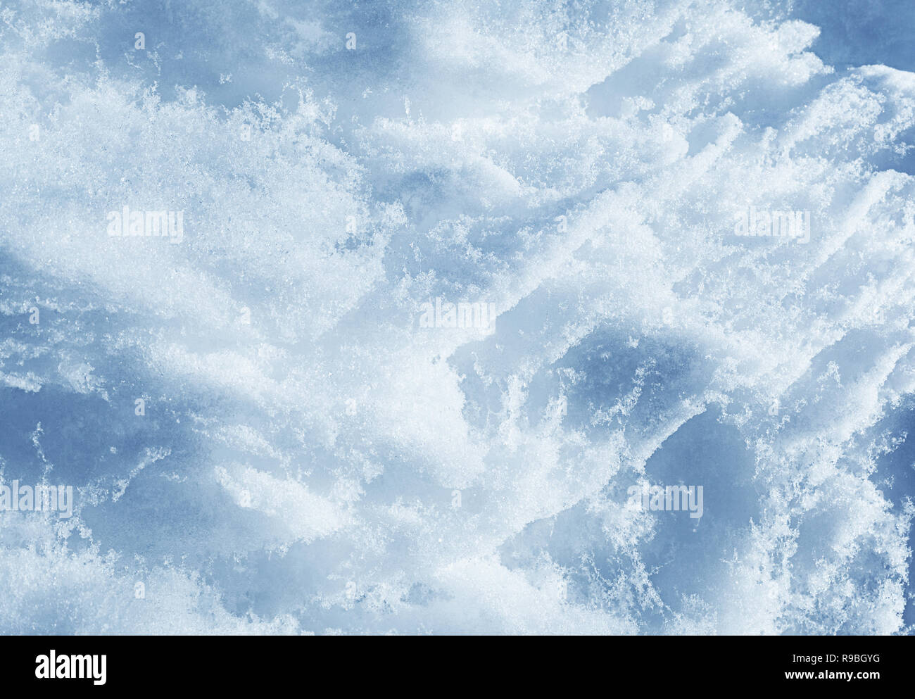 Closeup white snow detail structure with blue sky Stock Photo - Alamy