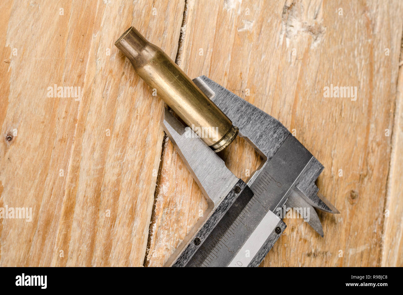 Bullet being measured with a caliper, a concept Stock Photo - Alamy