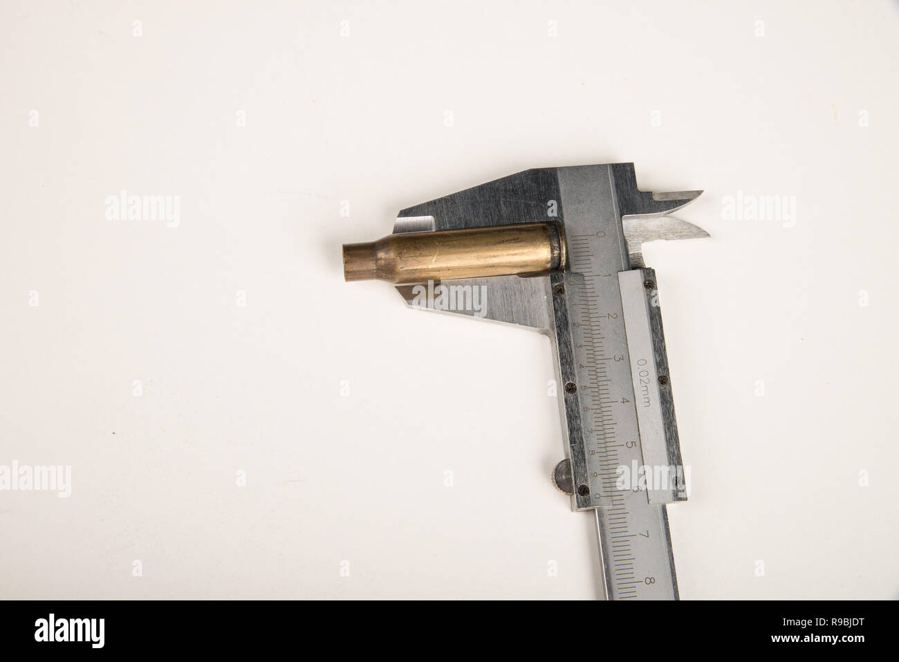 Bullet being measured with a caliper, a concept Stock Photo - Alamy