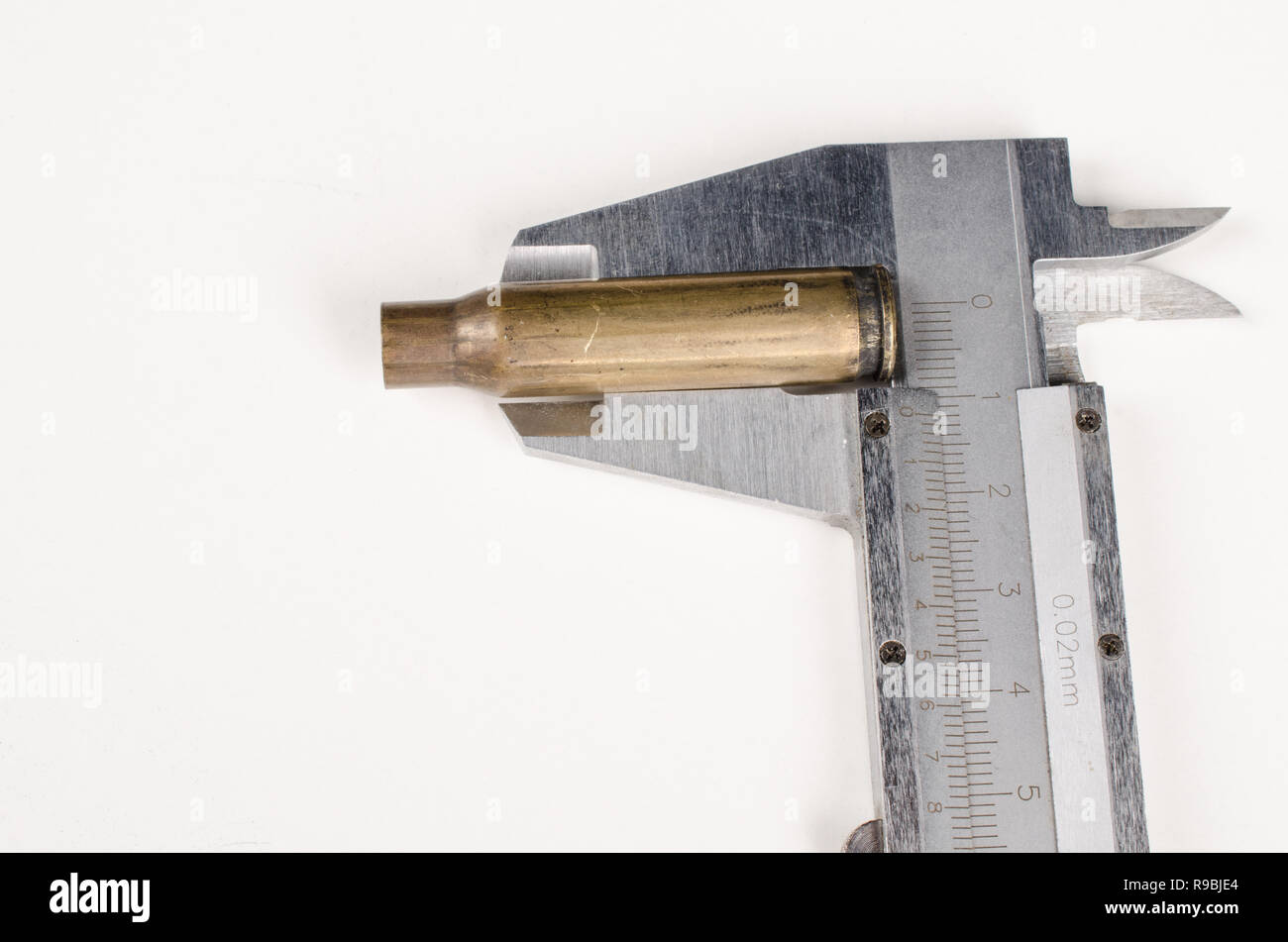 Bullet being measured with a caliper, a concept Stock Photo - Alamy