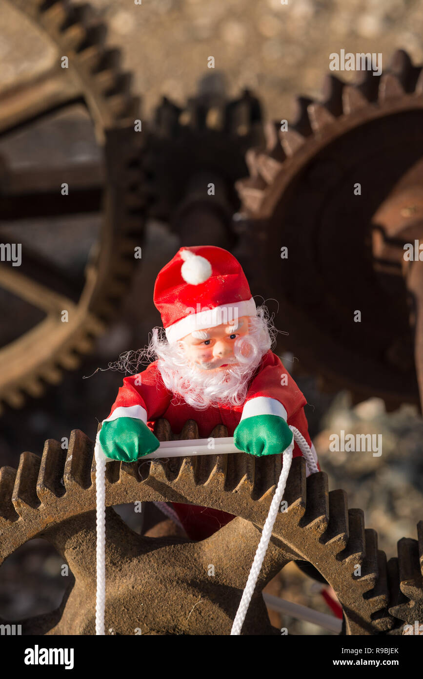 Santa in the cogwheels of consumerism, a concept Stock Photo - Alamy