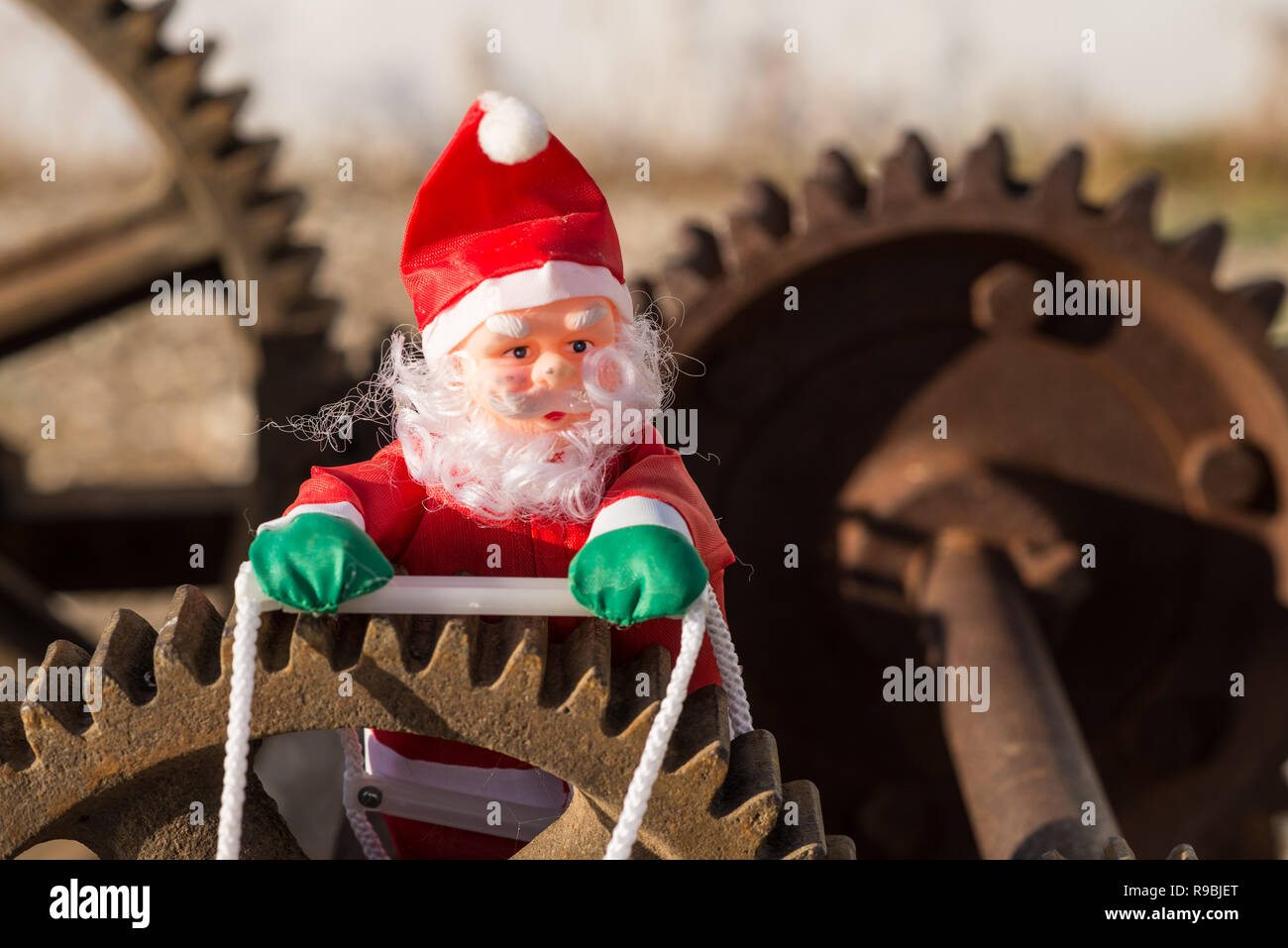 Santa in the cogwheels of consumerism, a concept Stock Photo - Alamy