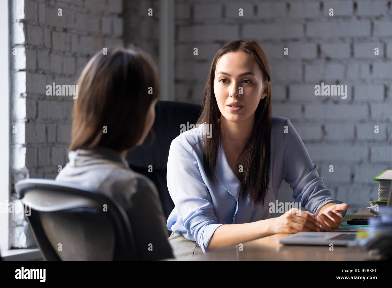 Serious professional female advisor consulting client at meeting Stock ...
