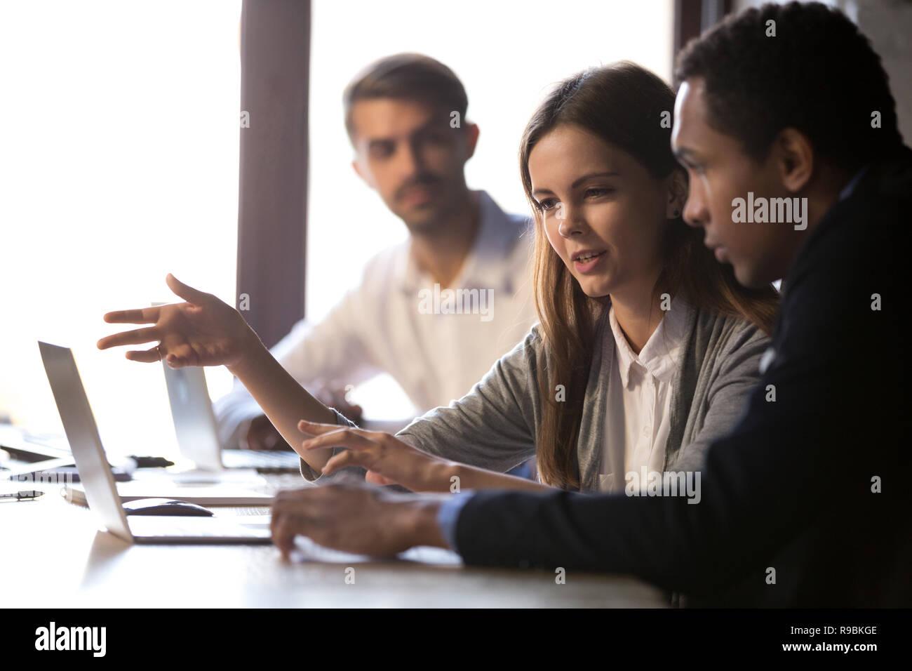 Diverse colleagues brainstorm computer hi-res stock photography and ...