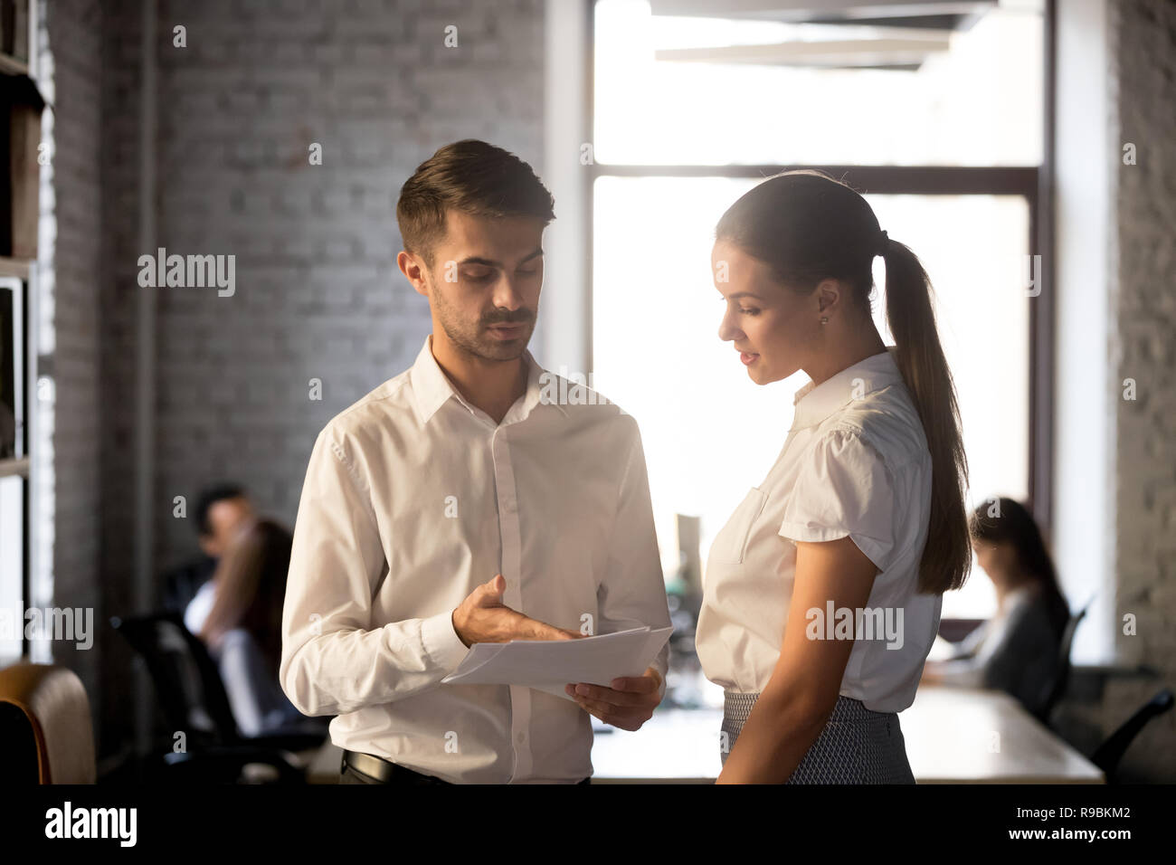 Executive manager giving instructions discussing paperwork stand Stock ...