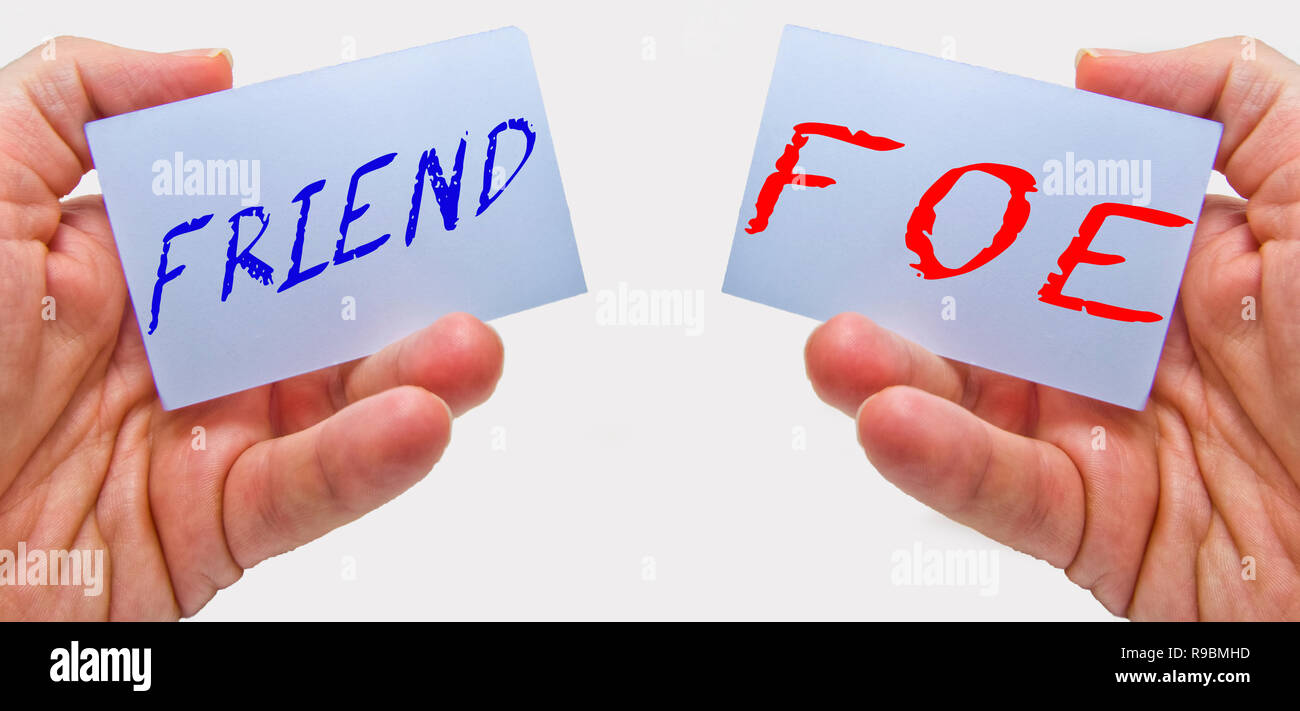 friend or foe choice signs on cards in man hands with a white ...
