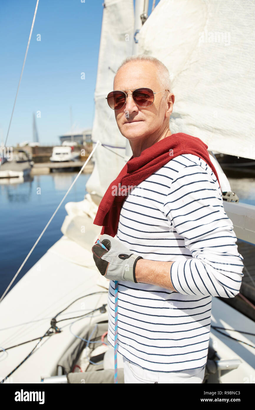 Rich man at own yacht Stock Photo - Alamy