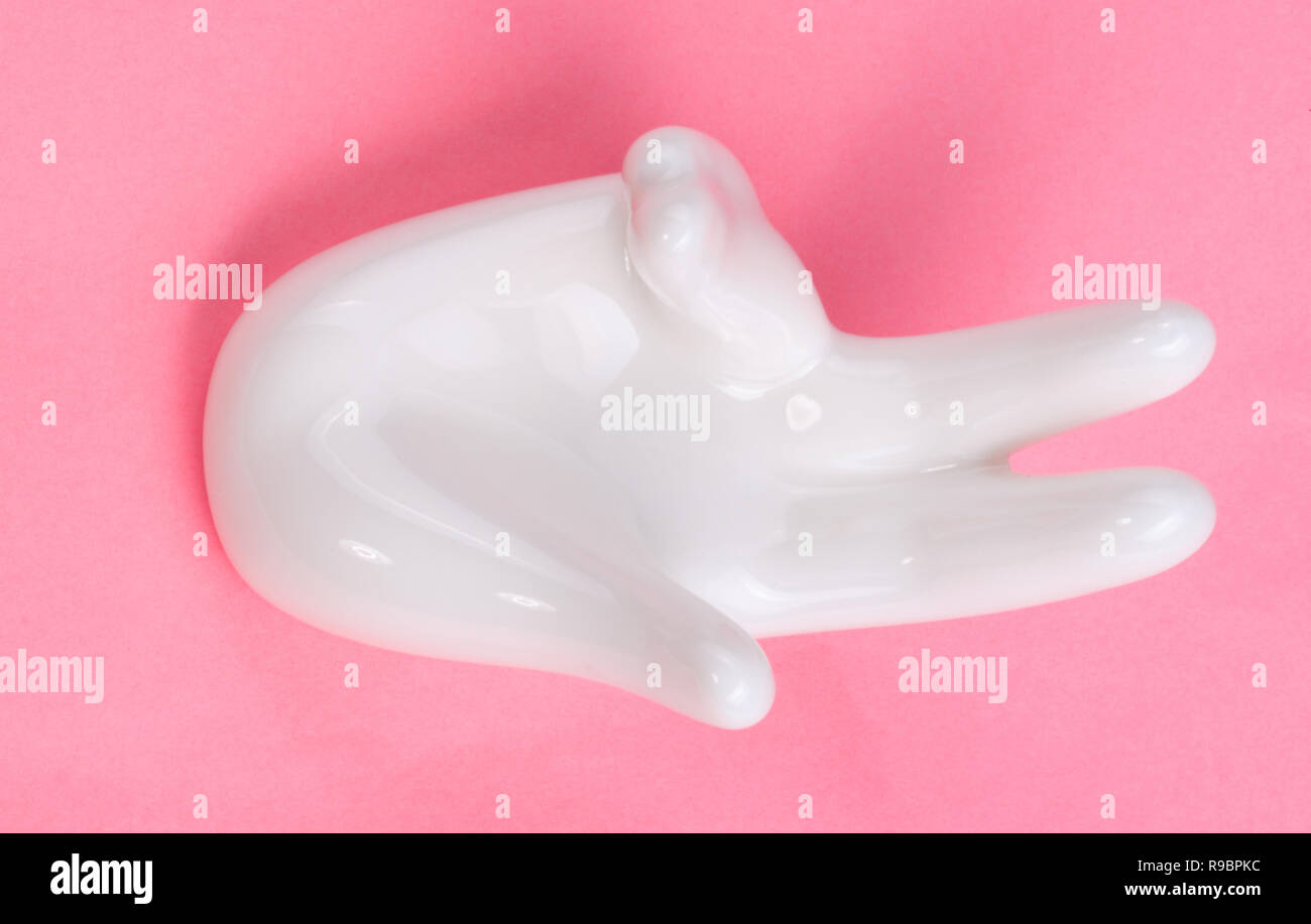 Ceramic stand with hand shape on pink background Stock Photo - Alamy