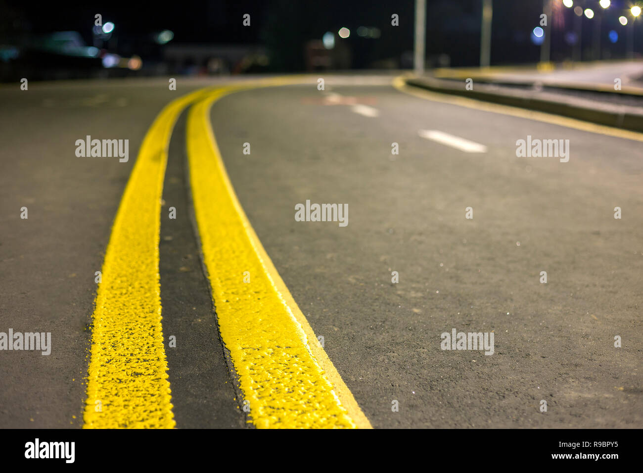 Wide bright yellow street marking sign line along modern wide smooth ...