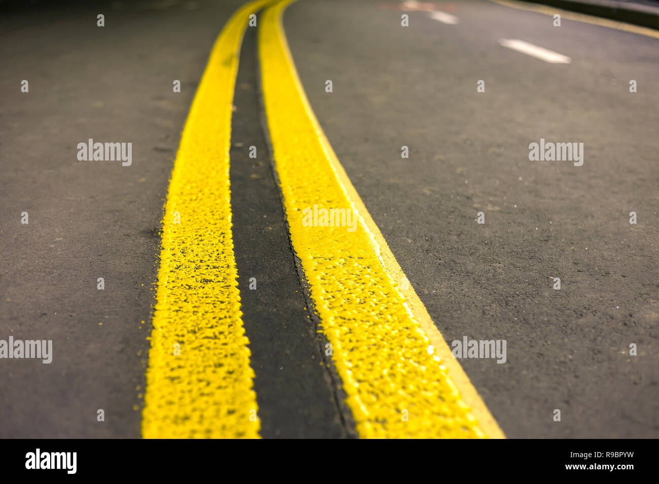 Wide bright yellow street marking sign line along modern wide smooth ...