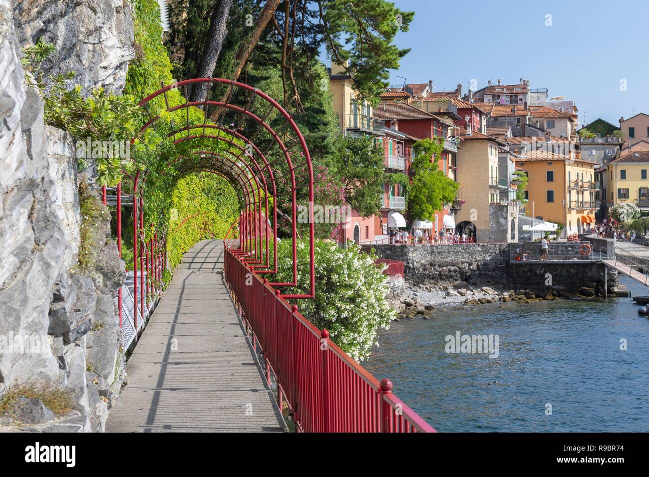 Red garden arch (Walk of Lovers) on coastline leading towards the ...